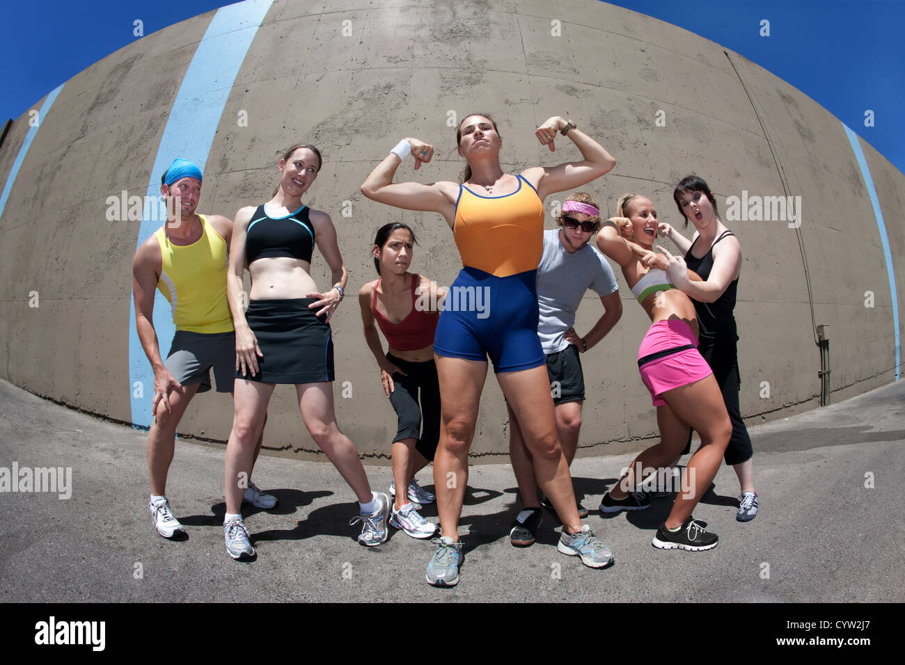 Pretty female runner poses and flexes with friends Stock Photo - Alamy