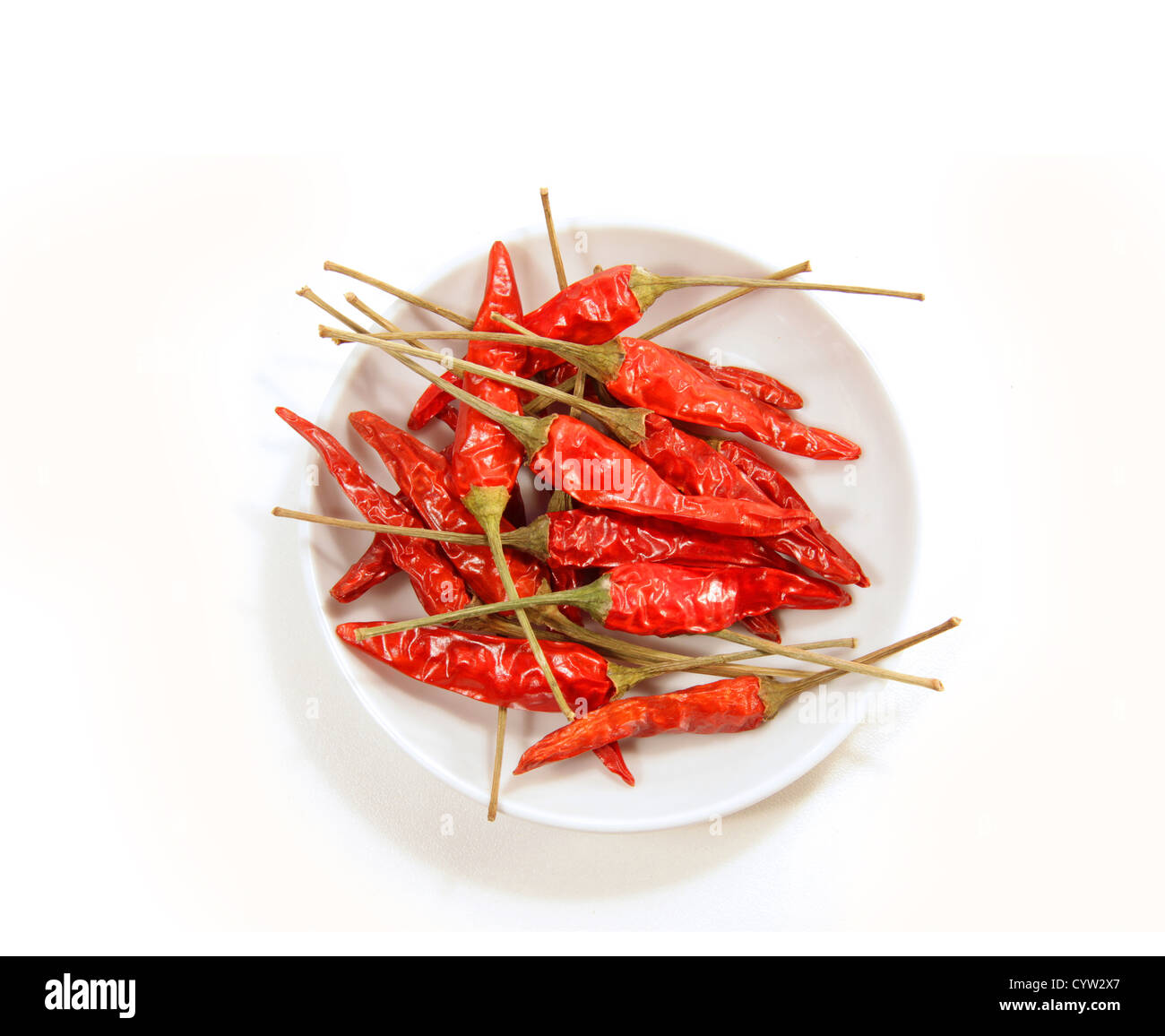 Bowl of red peppers on white background Stock Photo - Alamy