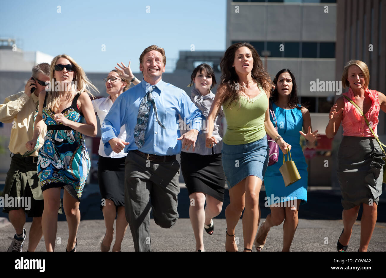 Group of hard working business men and women run down city street Stock ...