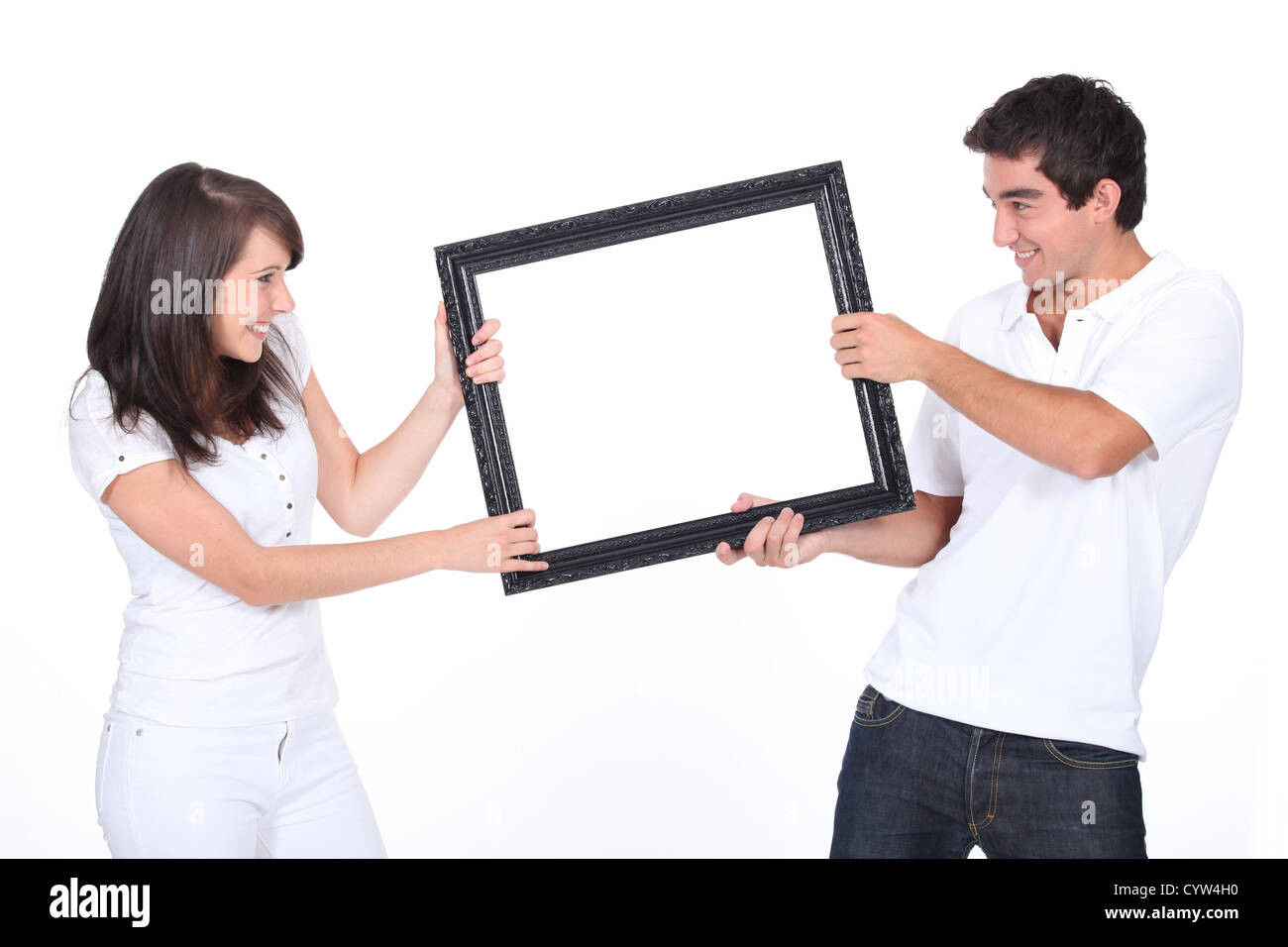 Couple fighting over blank picture frame Stock Photo - Alamy