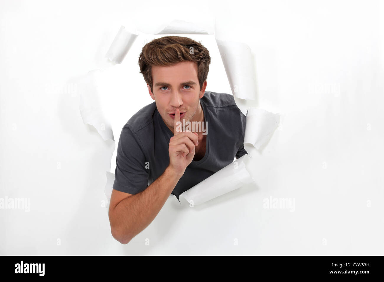 Man making shush gesture Stock Photo - Alamy