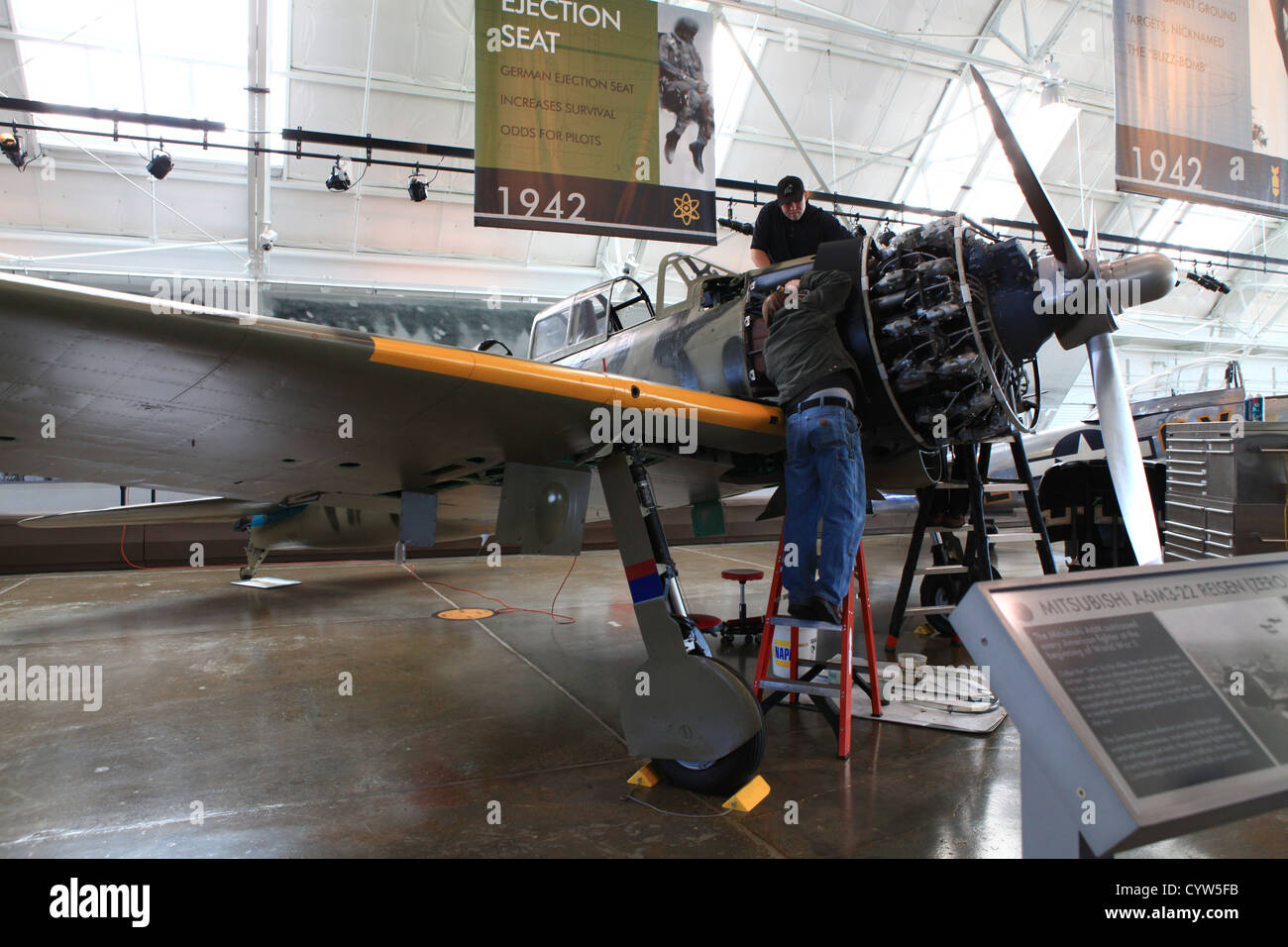 Mechanics doing scheduled maintenance on a Mitsubishi A6M3-22 Reisen in ...