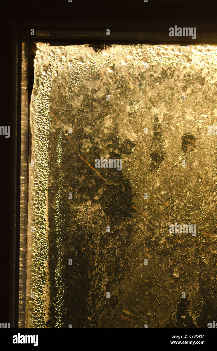Condensation and obscured vision through glass planes in wooden window ...