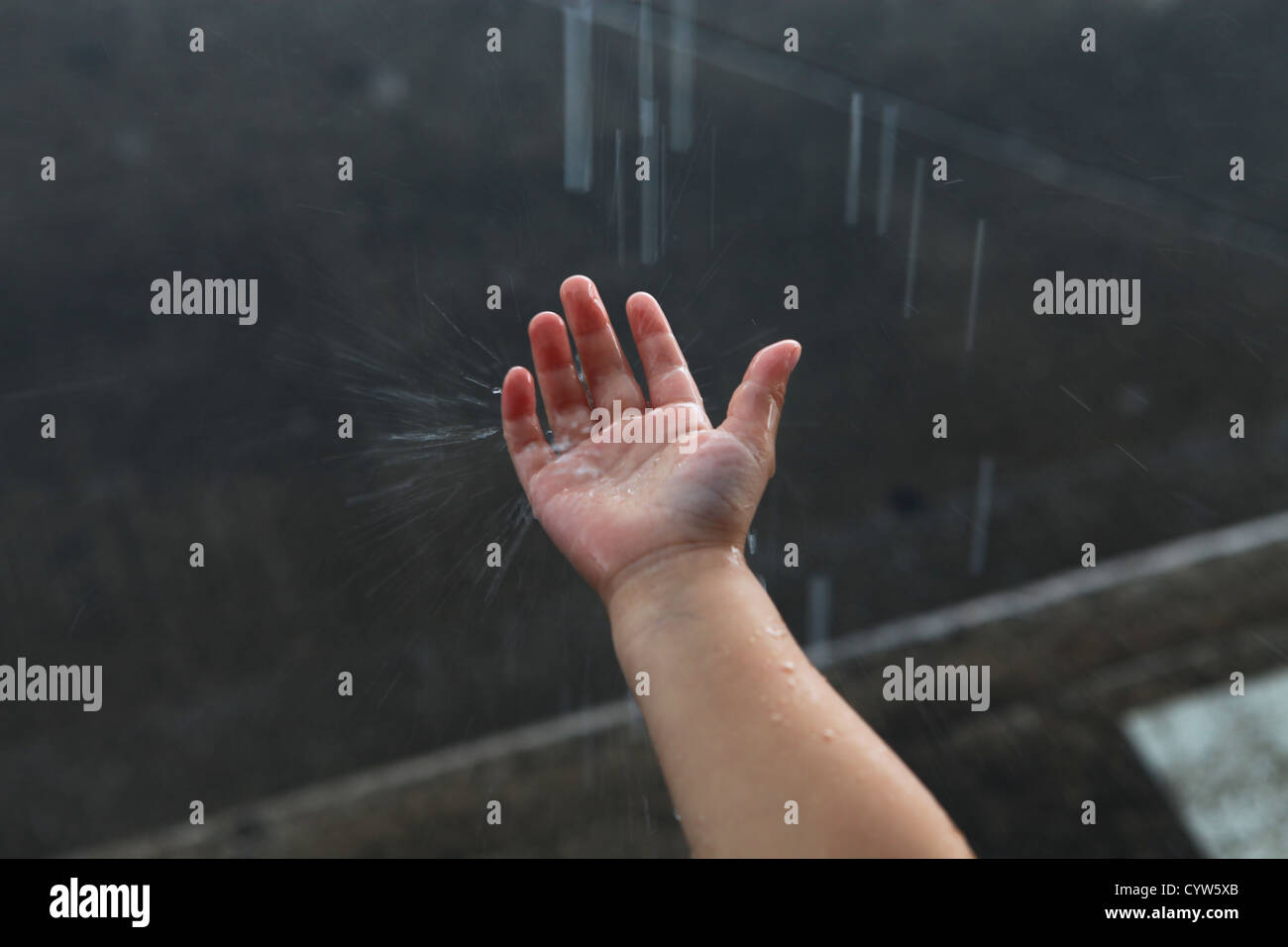 Raindrops on child's hands Stock Photo - Alamy