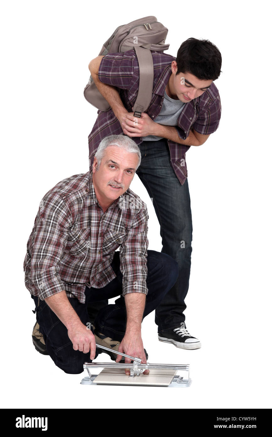 tiler and apprentice Stock Photo - Alamy