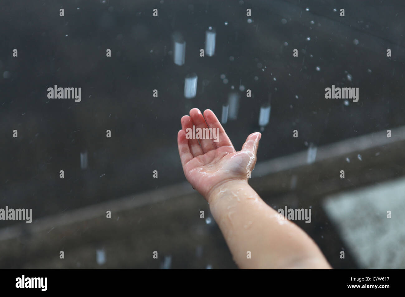 Raindrops on child's hands Stock Photo - Alamy