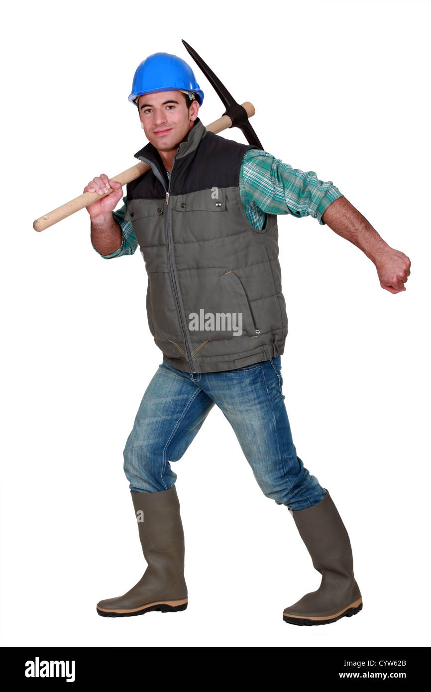 Worker with a pickaxe Stock Photo - Alamy