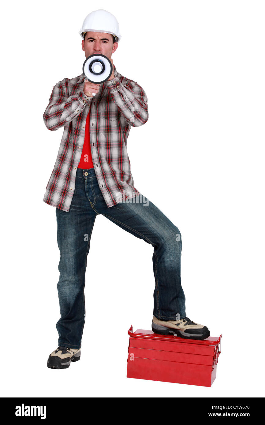Builder shouting into megaphone Stock Photo - Alamy