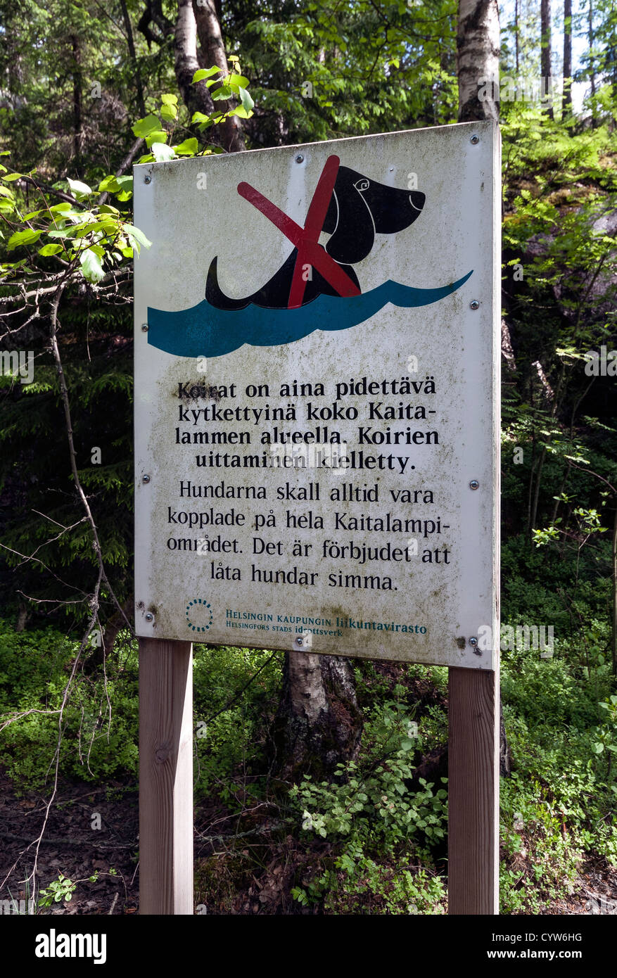 Finnish sign next to lake banning dogs from swimming in the water at ...