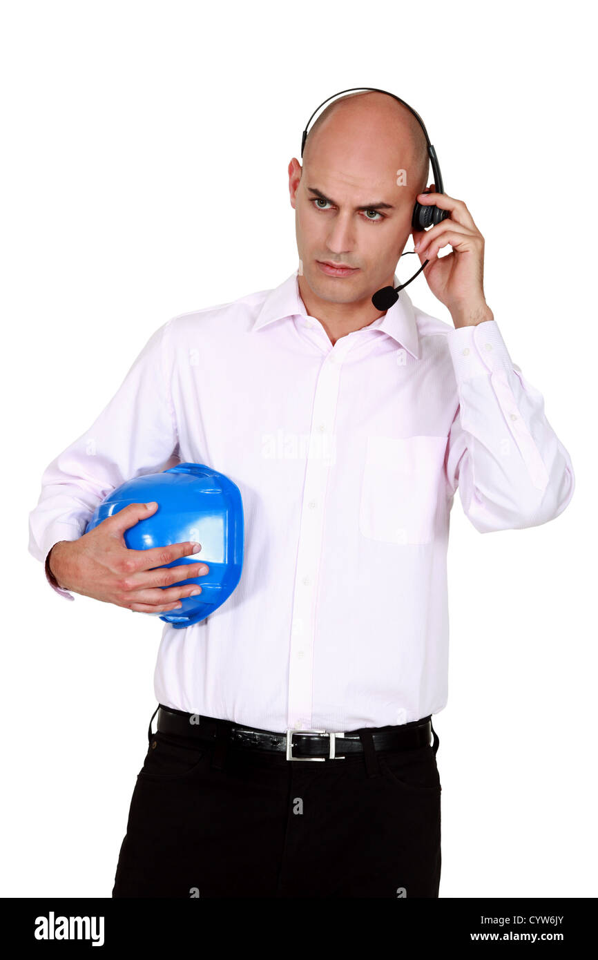 Construction worker wearing telephone head-set Stock Photo - Alamy