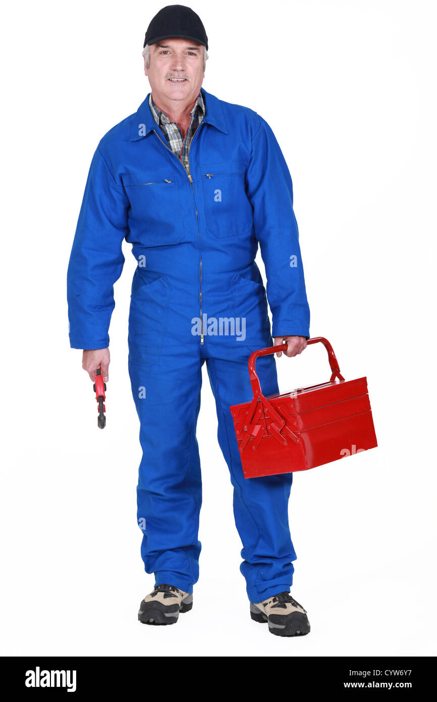 Tradesman holding a tool and his toolbox Stock Photo - Alamy