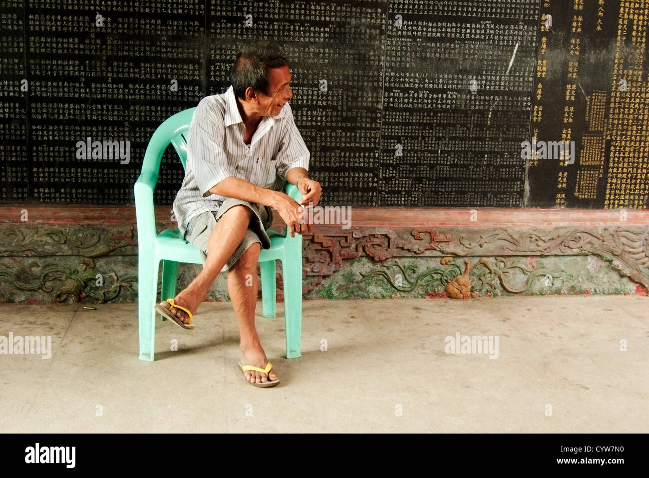 Man sitting inside Chinsese temple at Yangon's downtown Stock Photo - Alamy