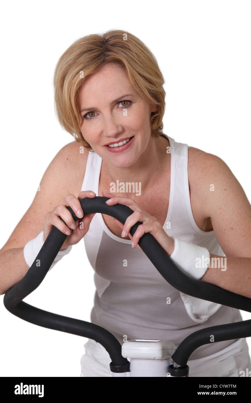 portrait of a woman on exercise bike Stock Photo - Alamy