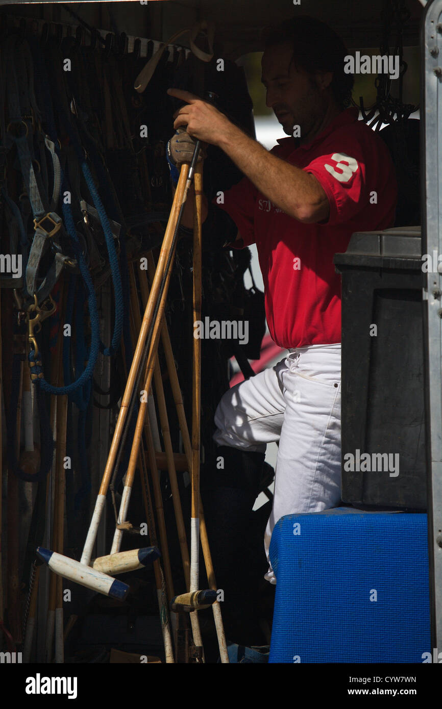 Polo player preparing equipment in trailer Stock Photo - Alamy