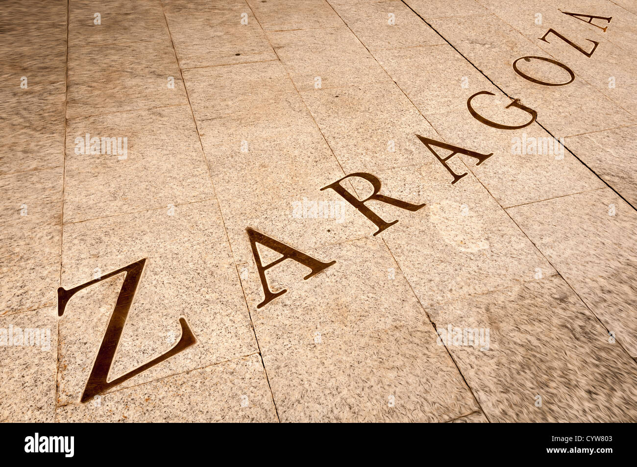Text written on marble tile of flooring. Sign of Zaragoza on ground ...