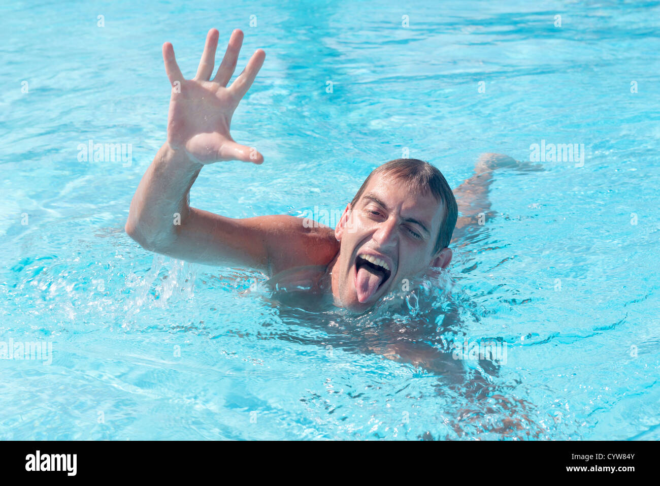 Young man kidding in blue pool Stock Photo - Alamy