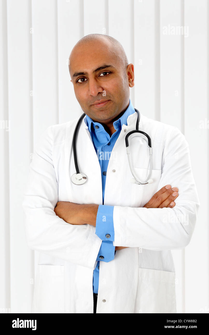 Hairless, dark-skinned doctor posing with arms folded Stock Photo - Alamy