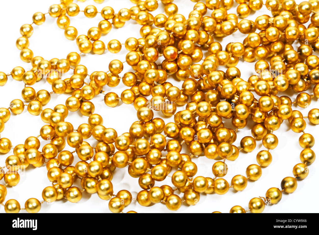 Golden beads new year decoration on white background Stock Photo - Alamy