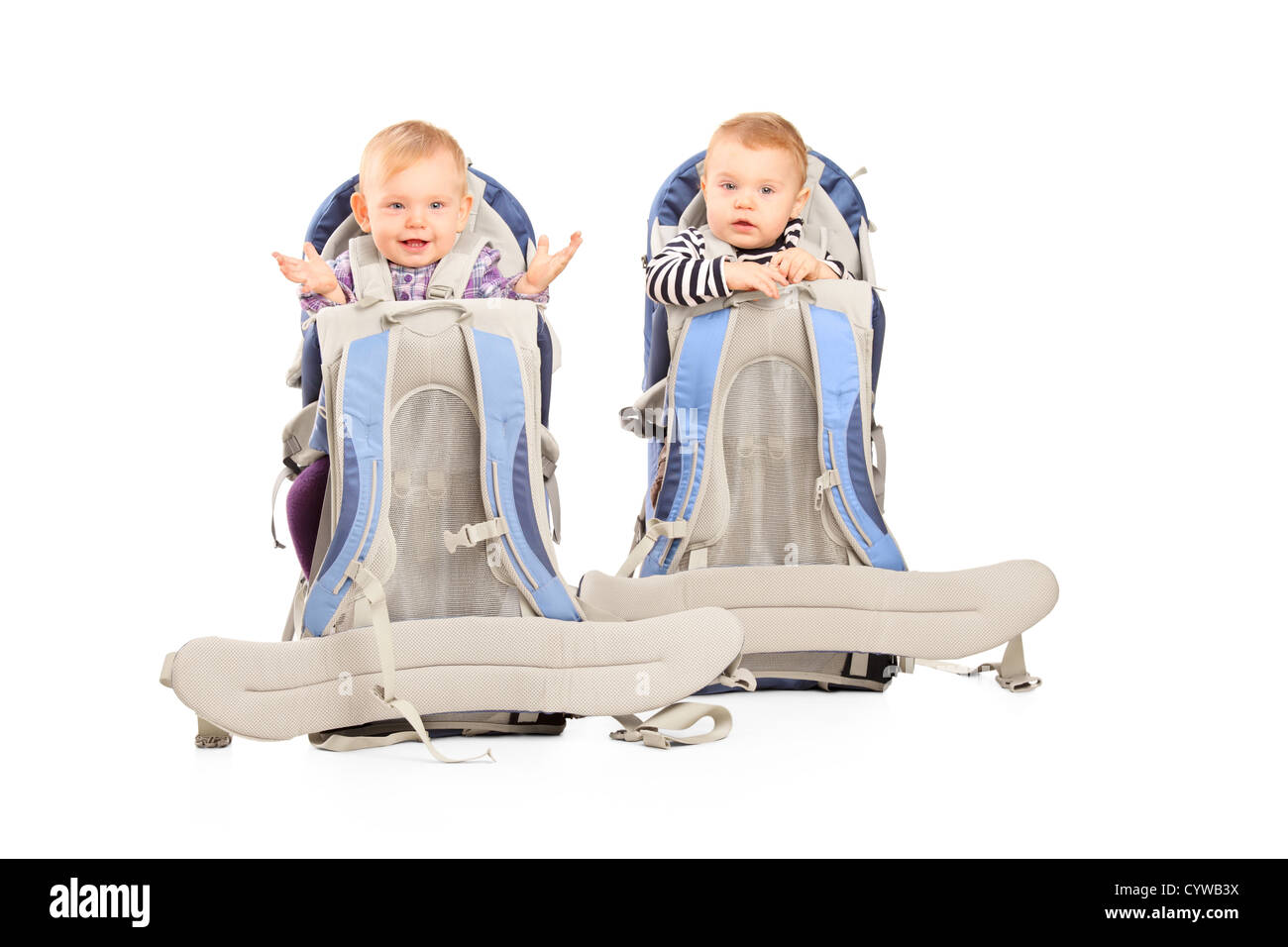 Happy toddlers in a baby carrier for hiking isolated on white ...