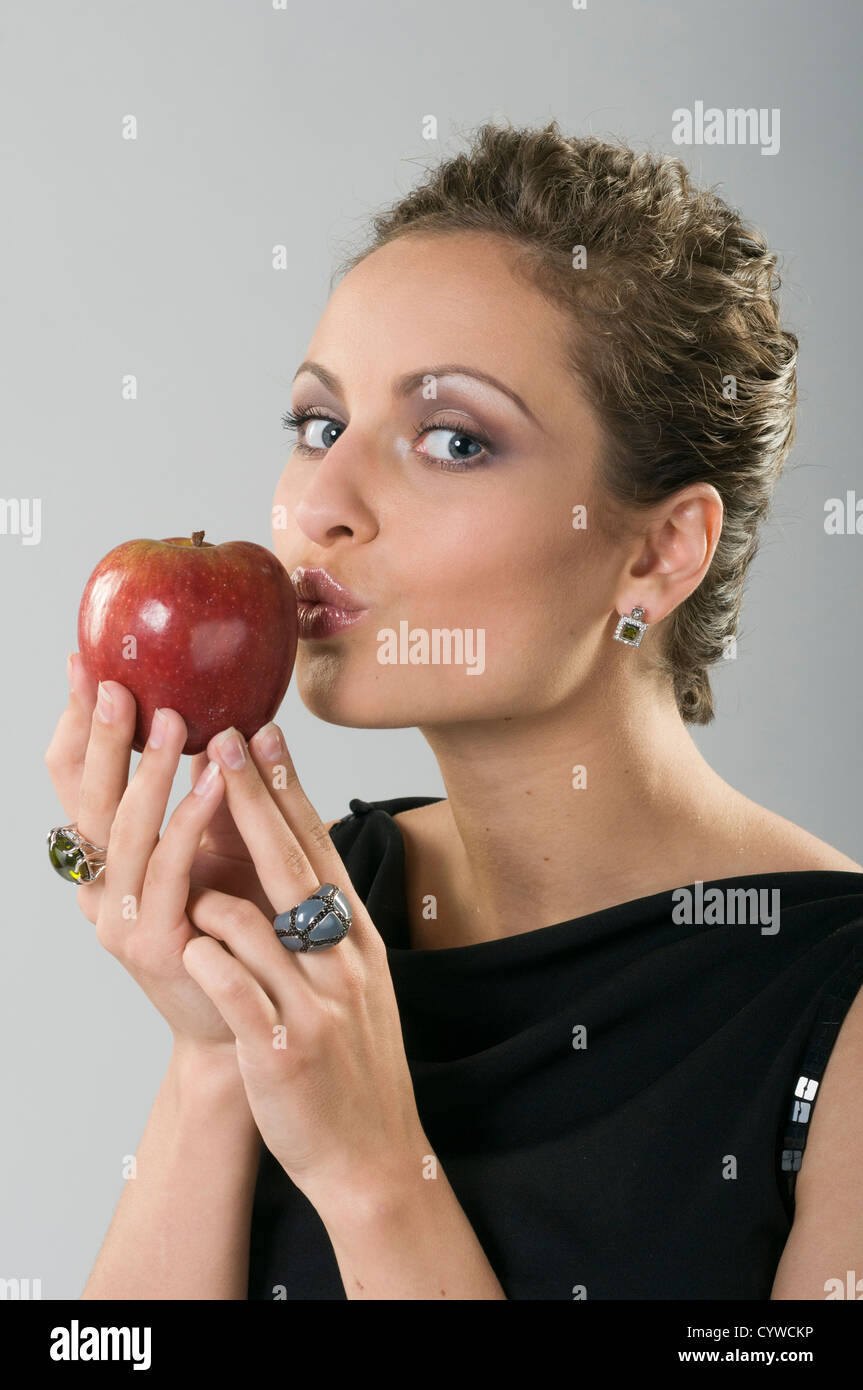 young beautiful woman caucasian studio apple kissing eating Stock Photo ...