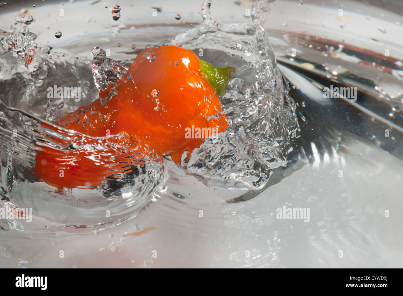 Washing yellow paprika in fresh water splash Stock Photo - Alamy