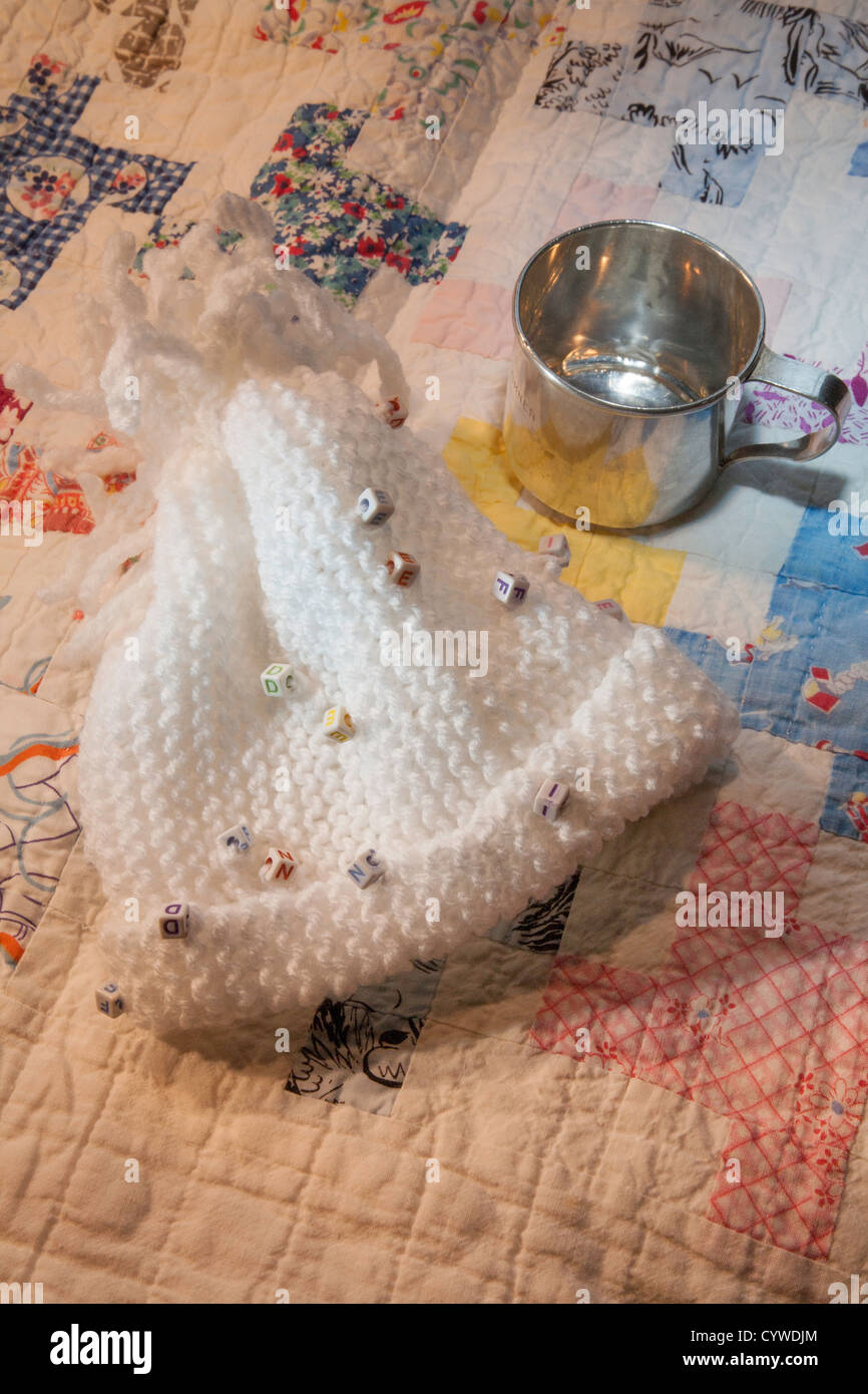 Hand Knitted Baby Cap and Silver Cup on Patchwork Quilt , USA Stock ...