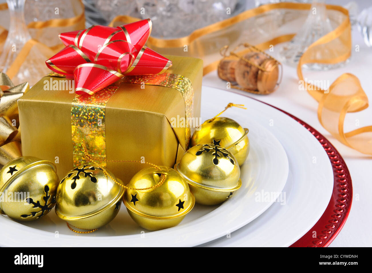 Closeup of a decorated holiday table with presents, bells, ribbons ...