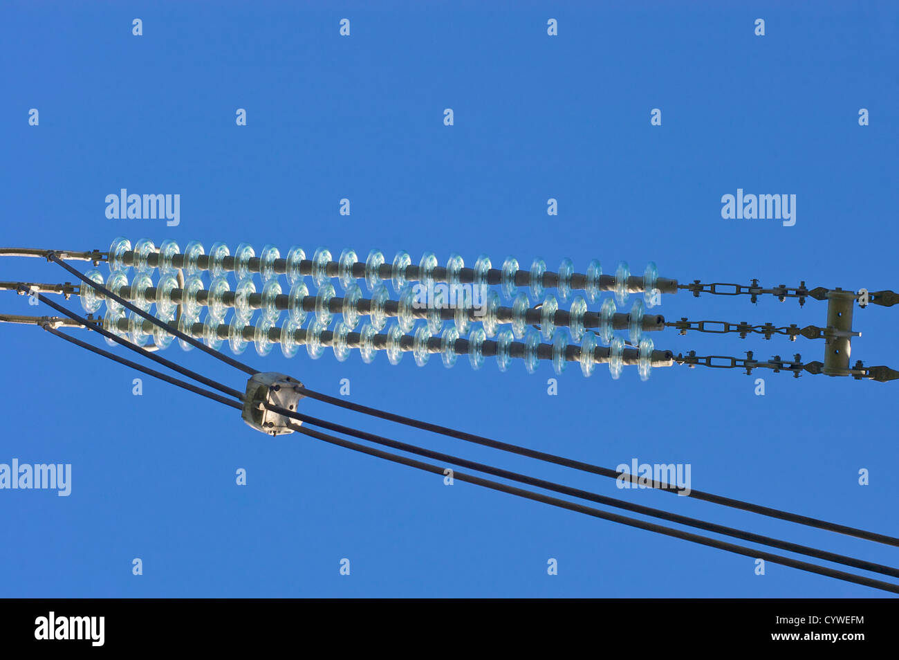 Insulators on high tension cables on electricity pylon Stock Photo - Alamy