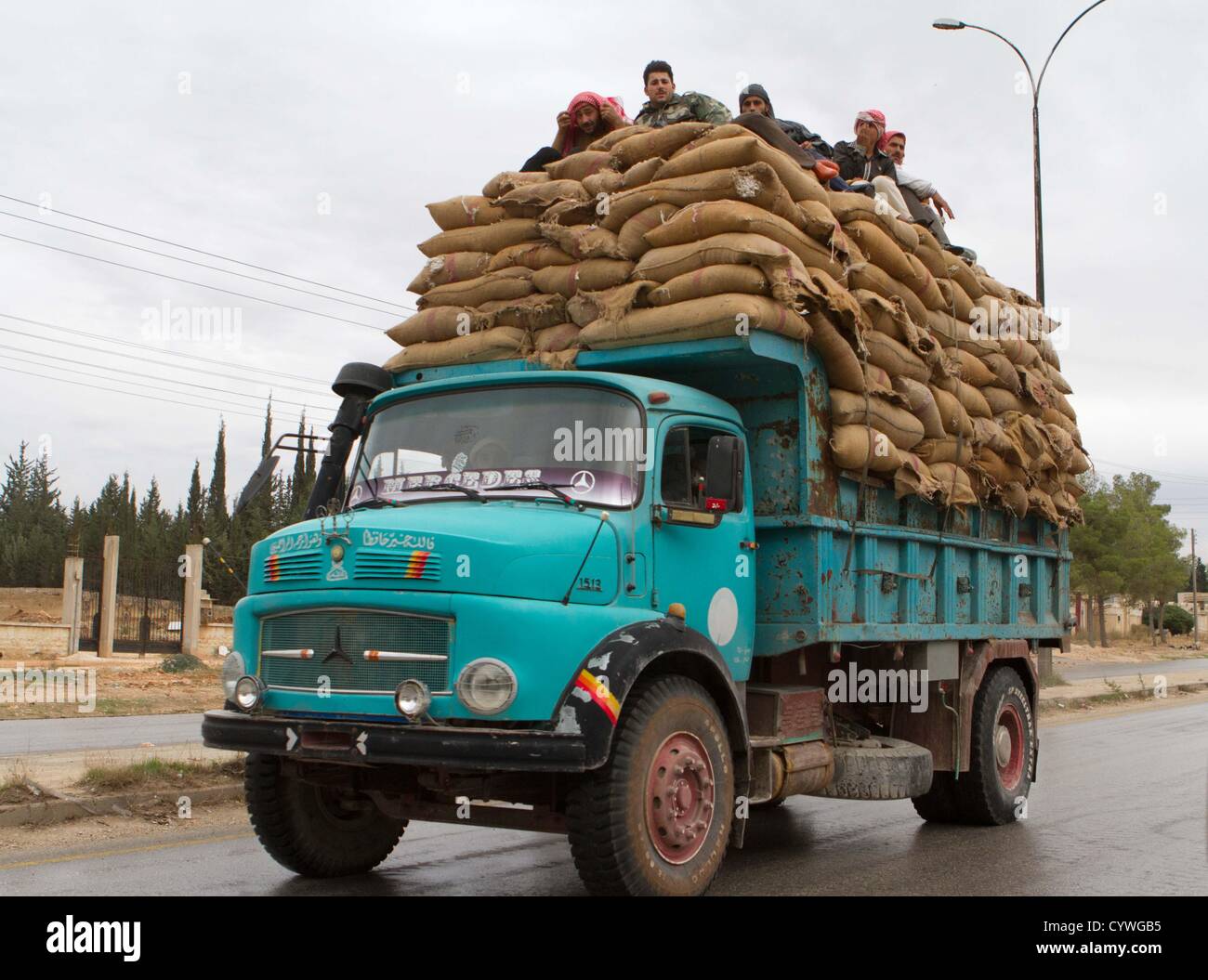 Men sit on top of an overloaded truck hi-res stock photography and ...