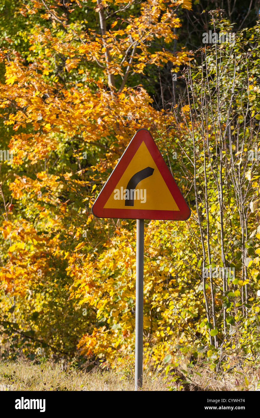 Warning sign for curve Stock Photo - Alamy