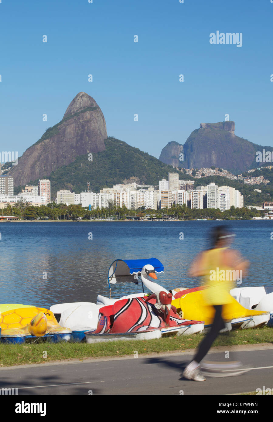 Person jogging on track around Lagoa Rodrigo de Freitas, Rio de Janeiro ...