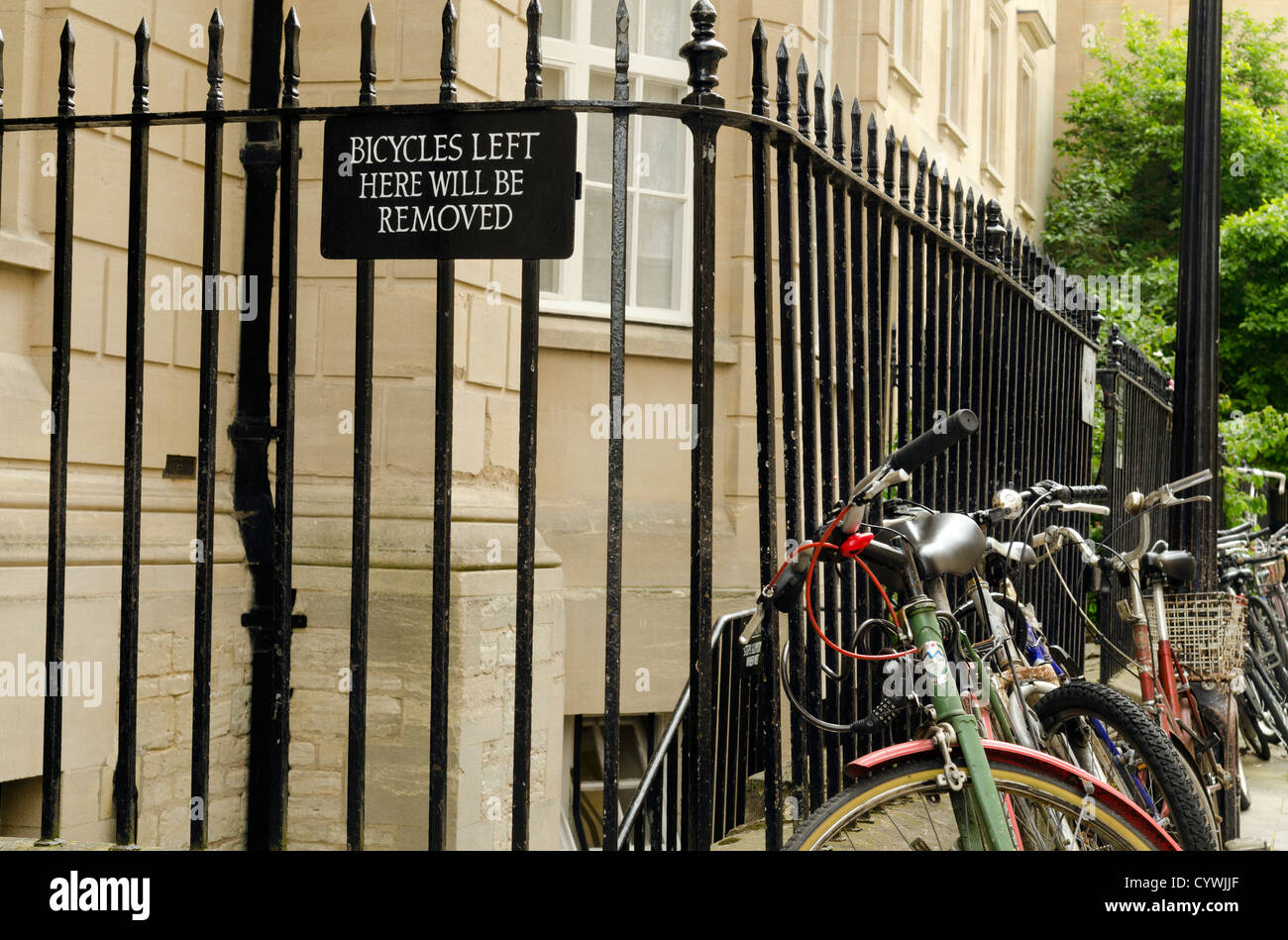 "Bicycles left here will be removed" sign on iron railings Oxford city ...