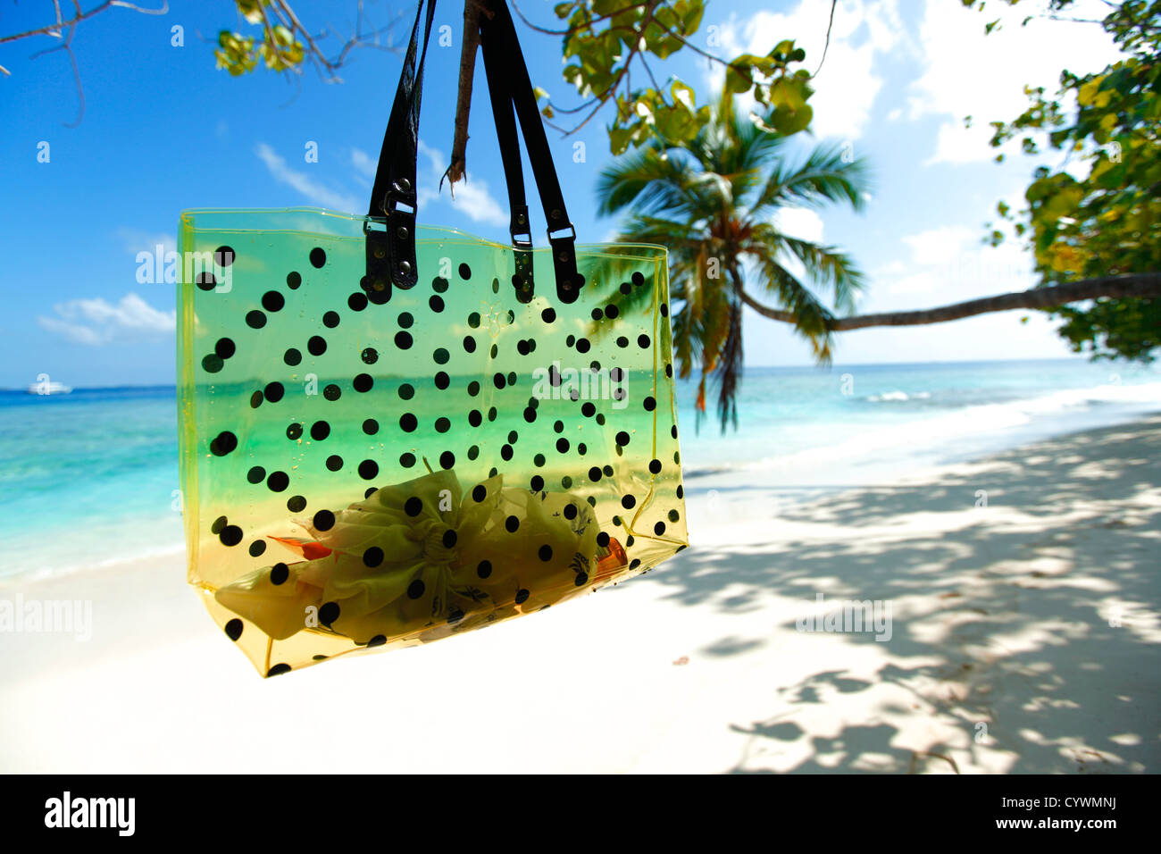 Colorful transparent beach bag on sea beach background Stock Photo - Alamy