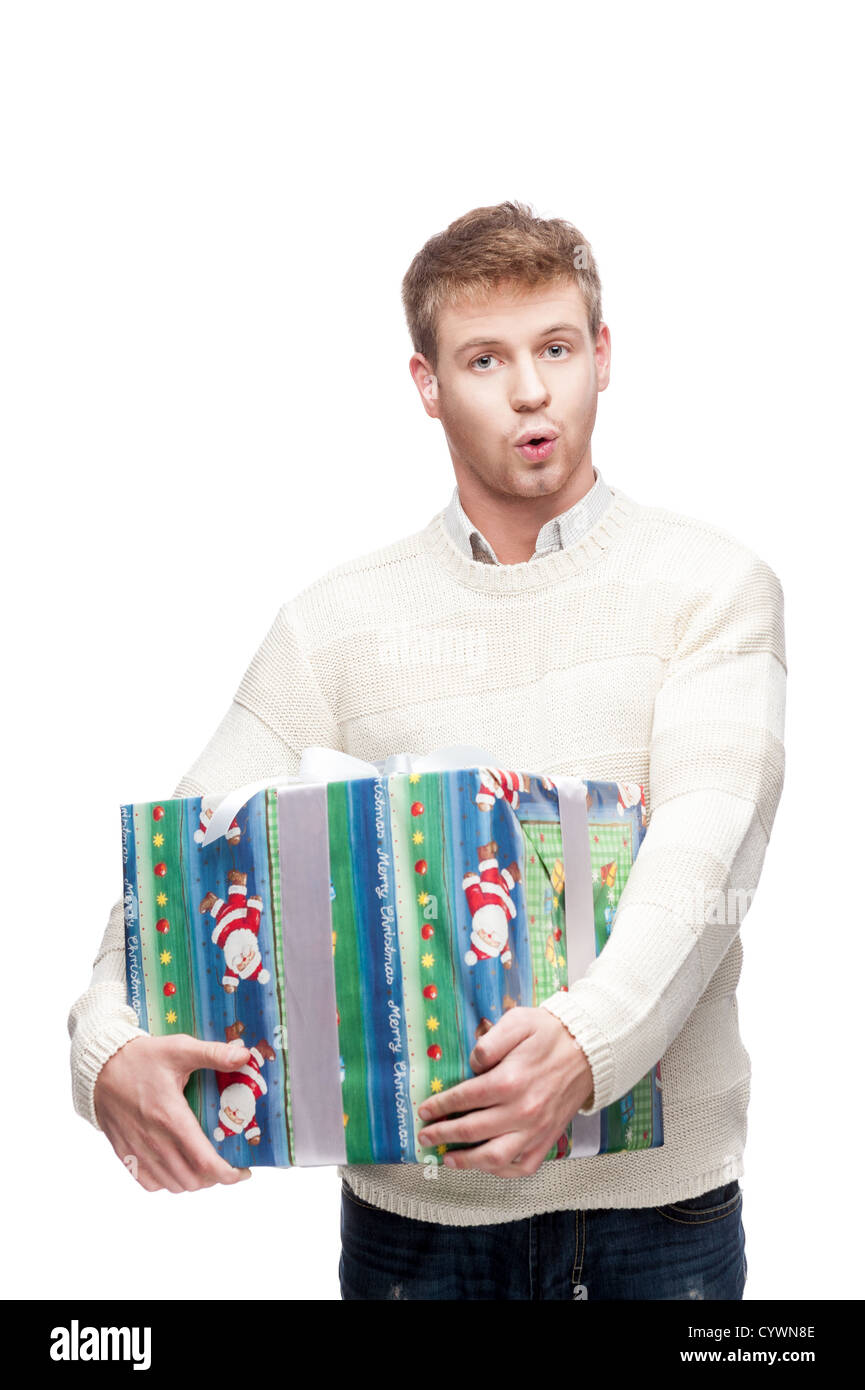 young surprised man holding big heavy gift Stock Photo - Alamy