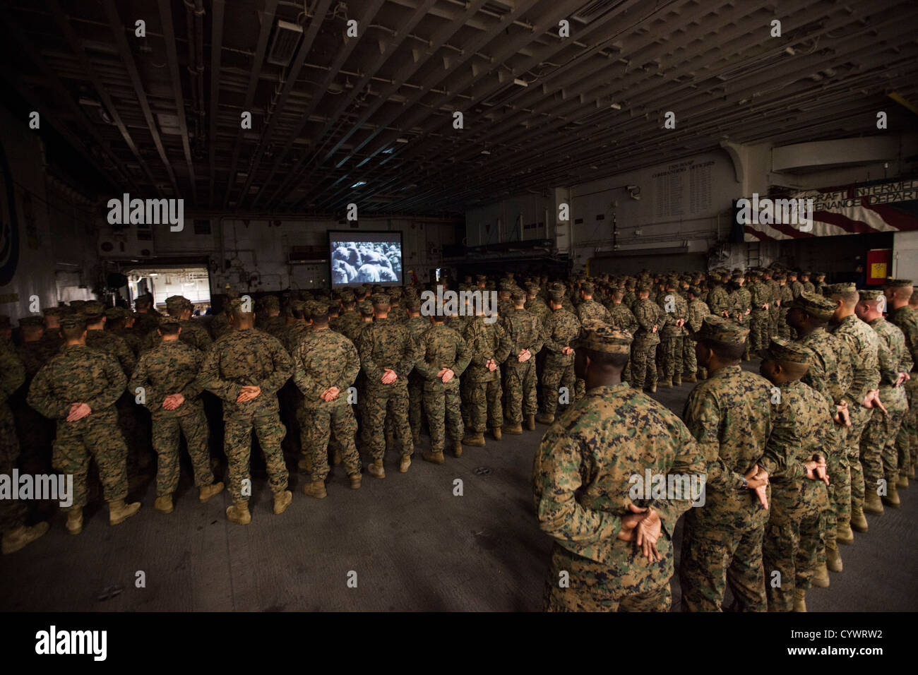 Marines and sailors aboard USS Wasp (LHD 1) watch the Commandant of the ...
