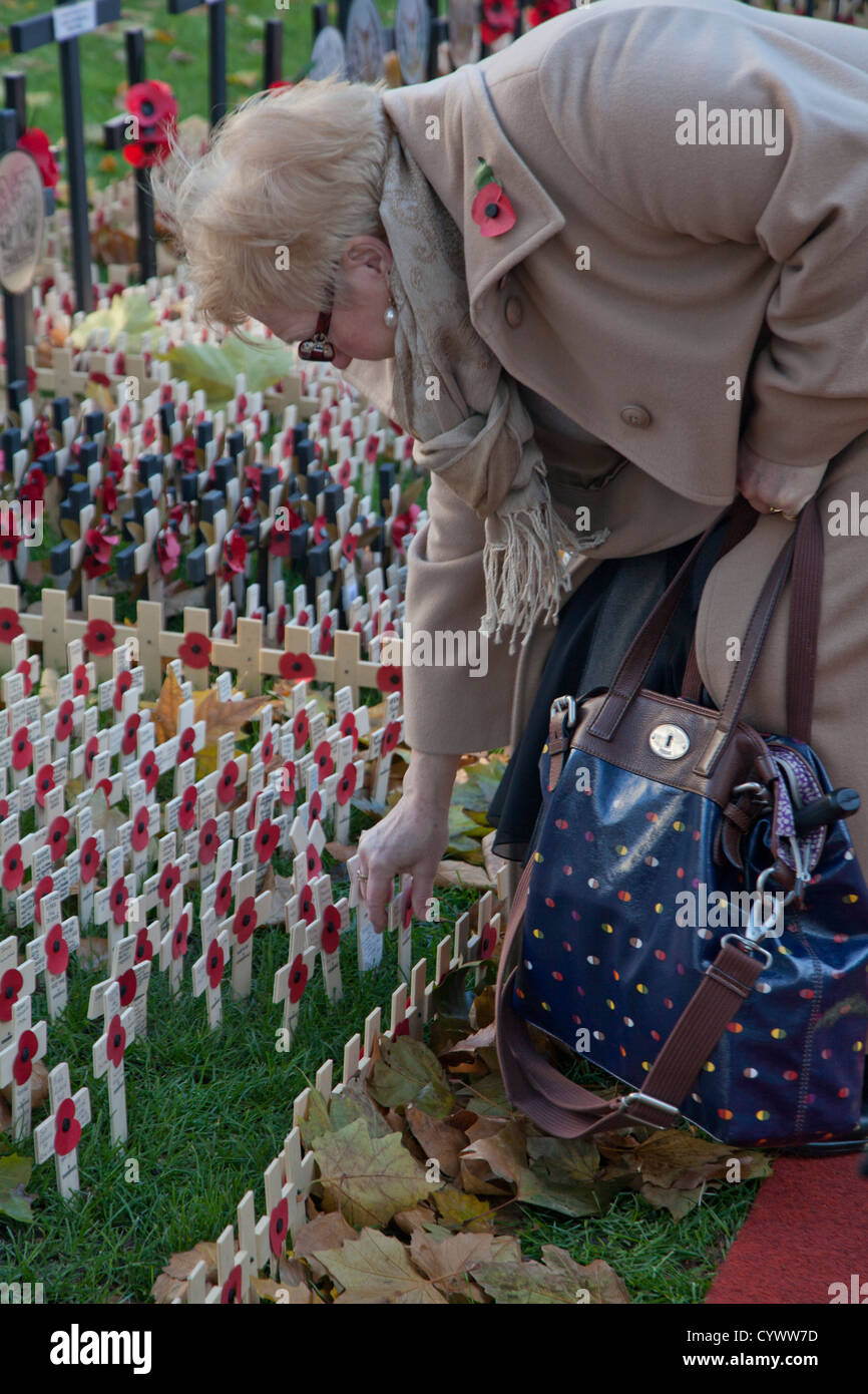 Elderly woman pays respect to their dead relatives and friends during ...