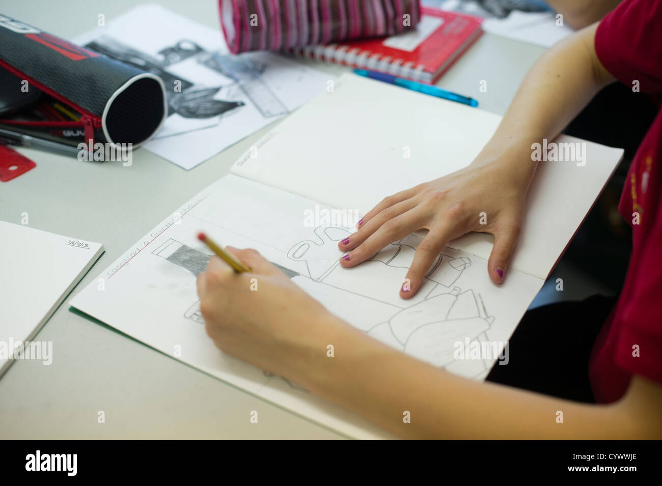 A student drawing in an art class at a secondary comprehensive school ...
