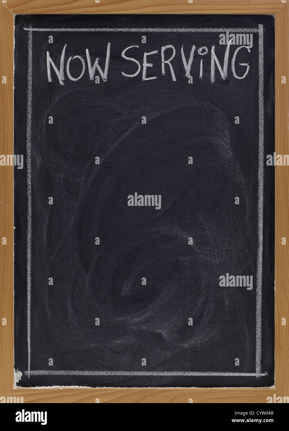 now serving - white chalk handwriting on blackboard with blank space ...