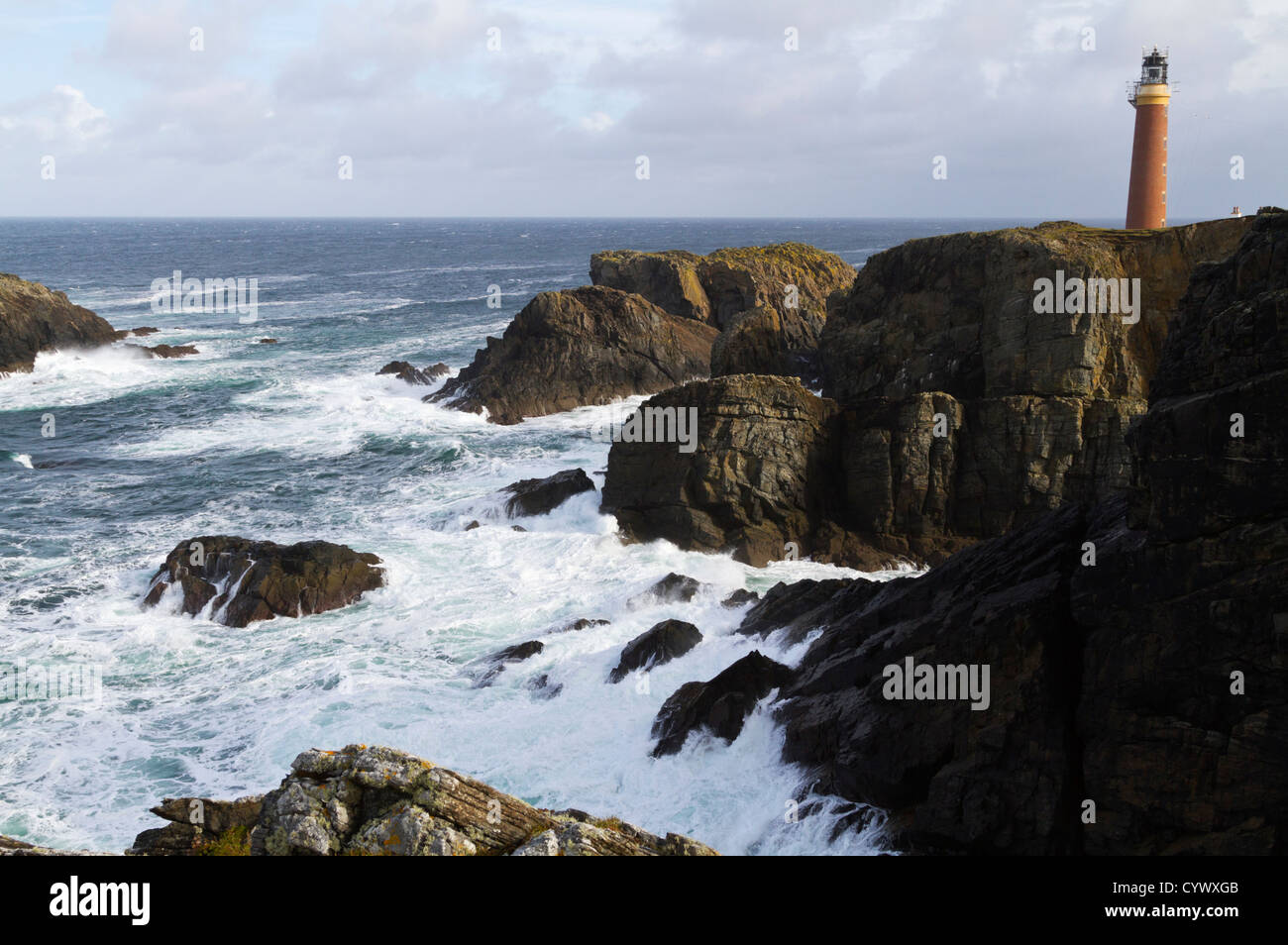 Waves break on the rocks below the Butt of Lewis lighthouse at the ...