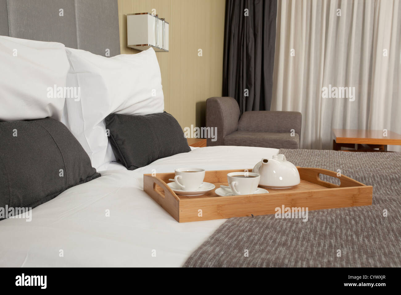 Tray with coffee on a bed in a hotel room Stock Photo - Alamy