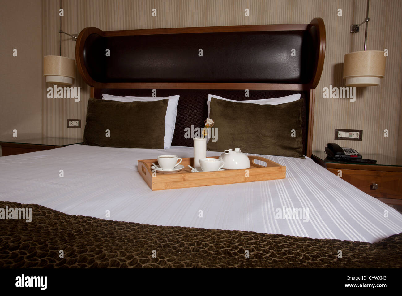 Tray with coffee on a bed in a hotel room Stock Photo - Alamy