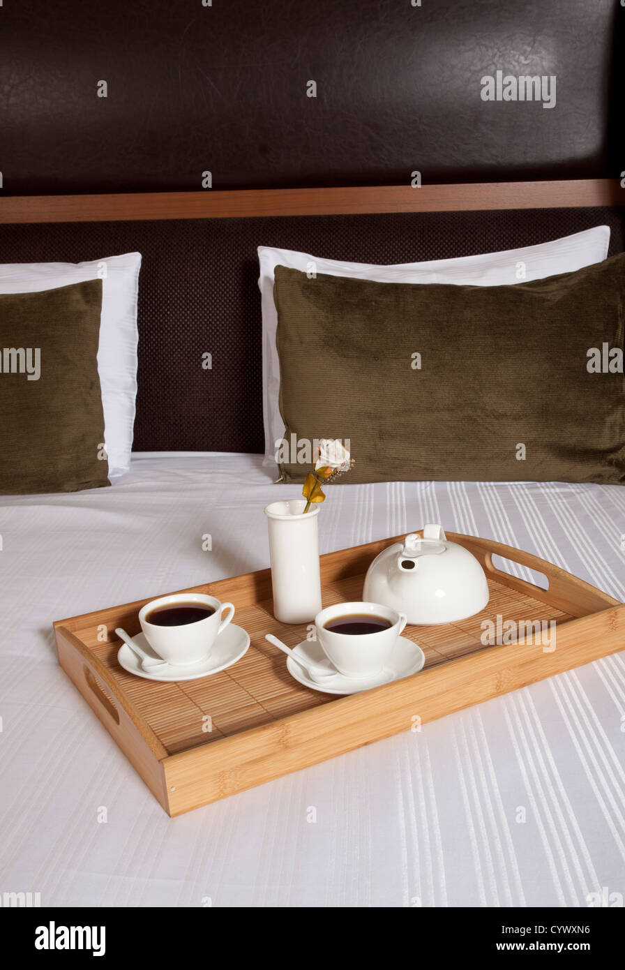 Tray with coffee on a bed in a hotel room Stock Photo - Alamy
