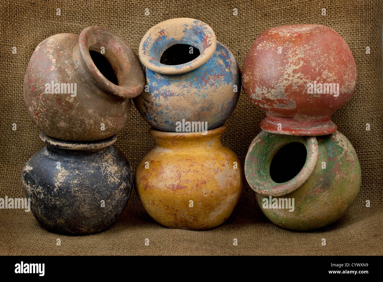 six small plant clay pots (mass produced planters) with rough color ...