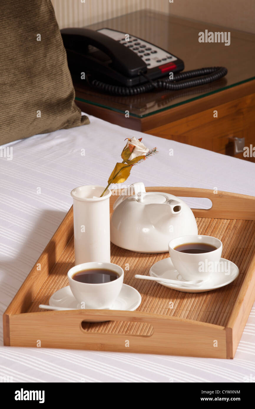 Tray with coffee on a bed in a hotel room Stock Photo - Alamy