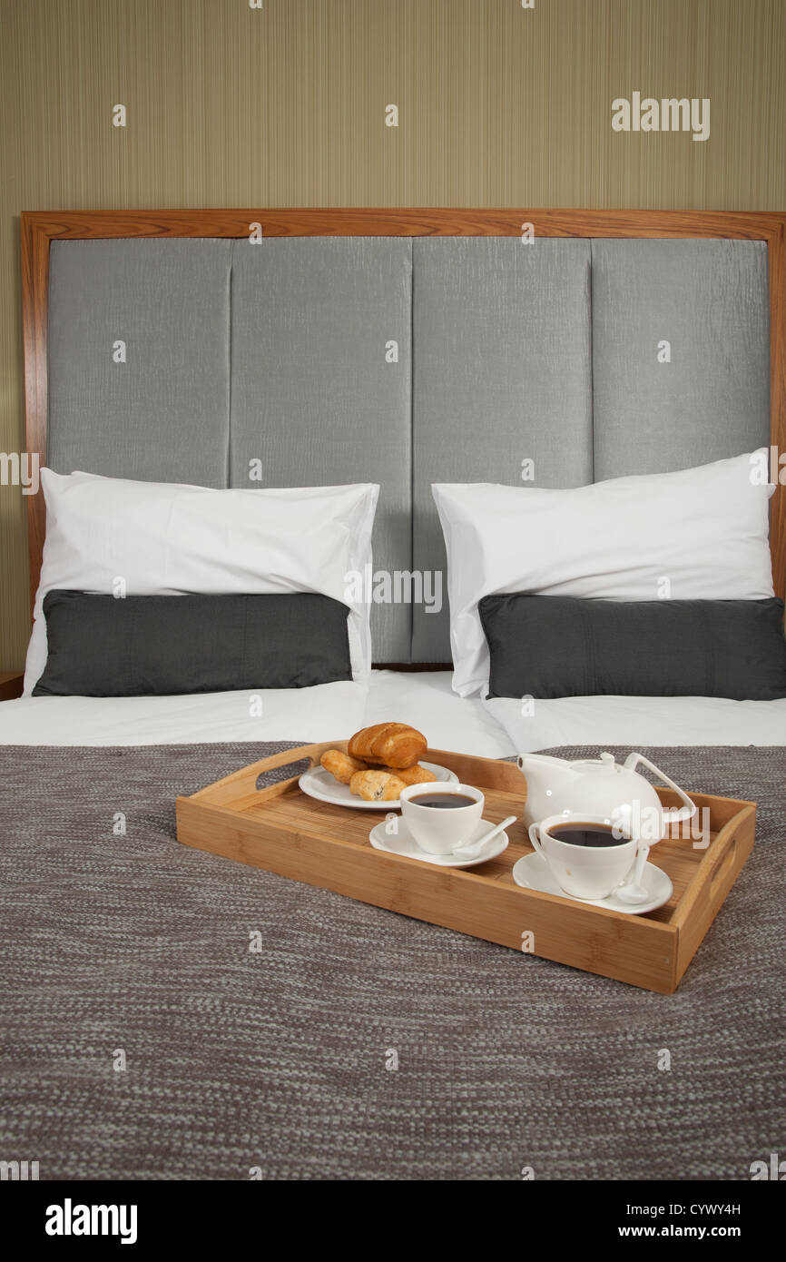 Tray with coffee on a bed in a hotel room Stock Photo - Alamy
