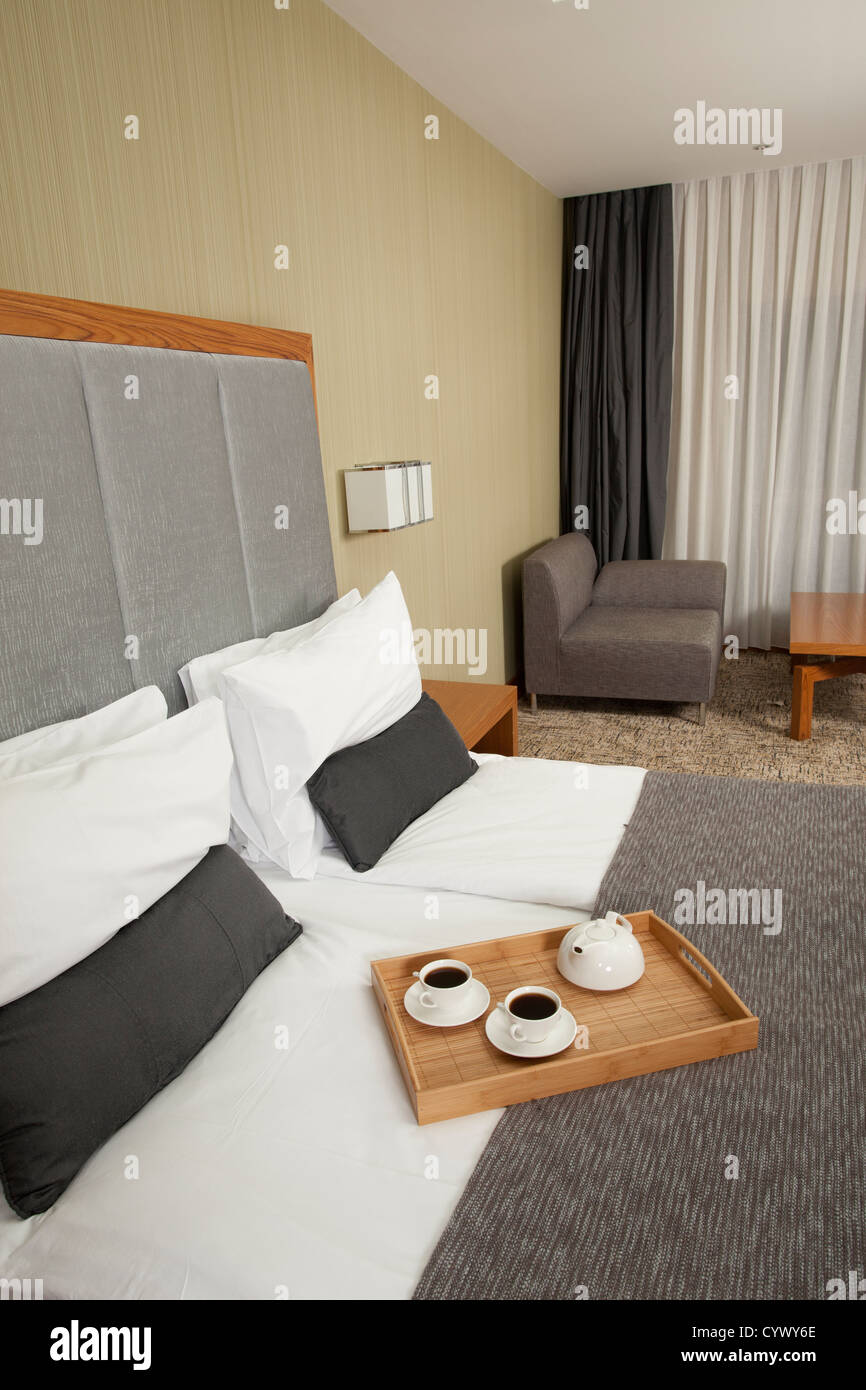 Tray with coffee on a bed in a hotel room Stock Photo - Alamy