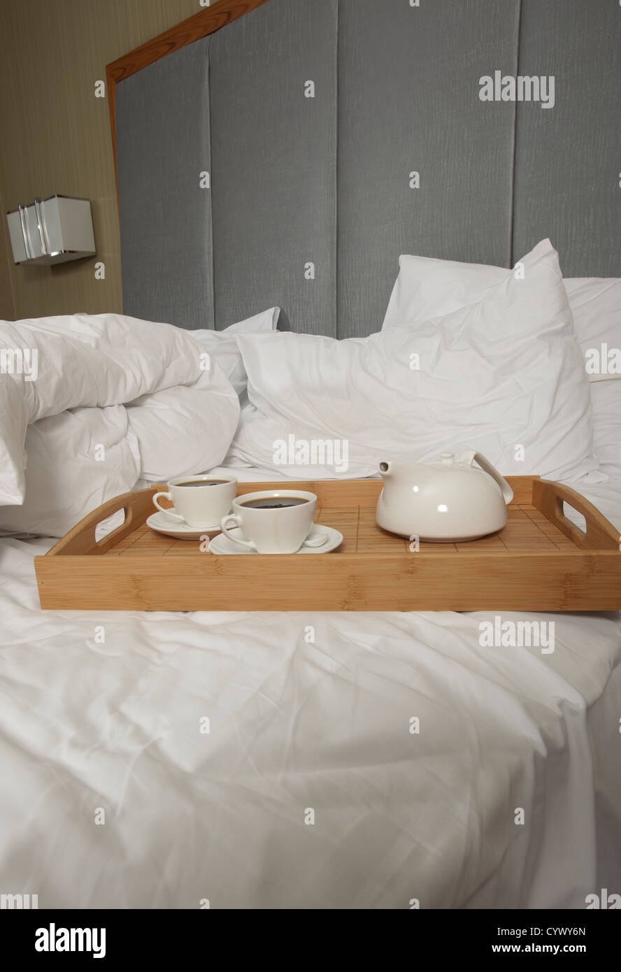 Tray with coffee on a bed in a hotel room Stock Photo - Alamy