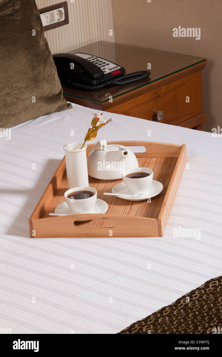 Tray with coffee on a bed in a hotel room Stock Photo - Alamy