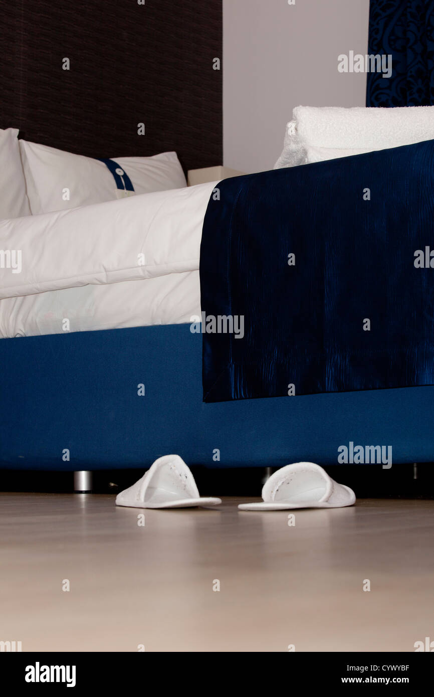 Slippers on the floor of hotel room Stock Photo - Alamy