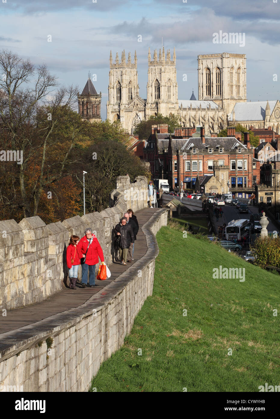 People walking along York City walls with York Minster in the ...